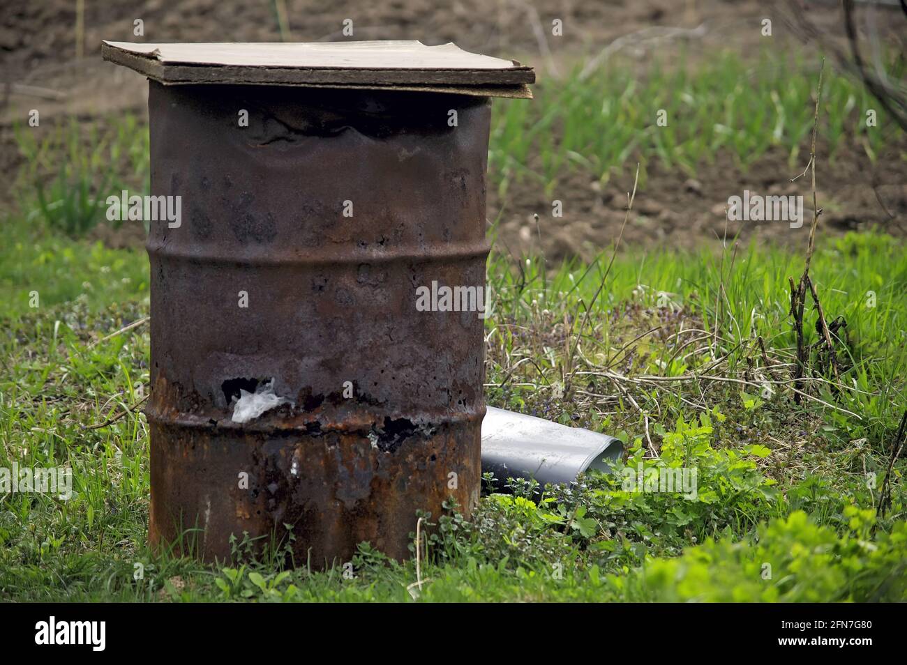 old iron barrel in the garden, in the spring Stock Photo - Alamy
