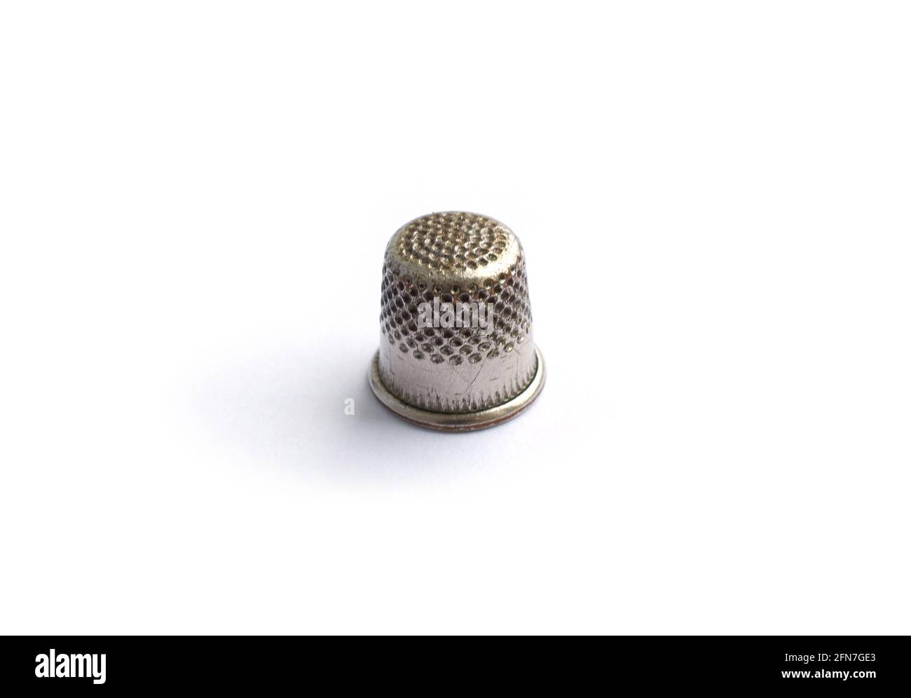 Sewing tools. An antique thimble on isolated on a white background ...