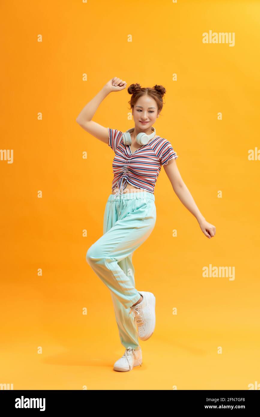 Attractive careless cheerful girl jumping listening bass having fun ...