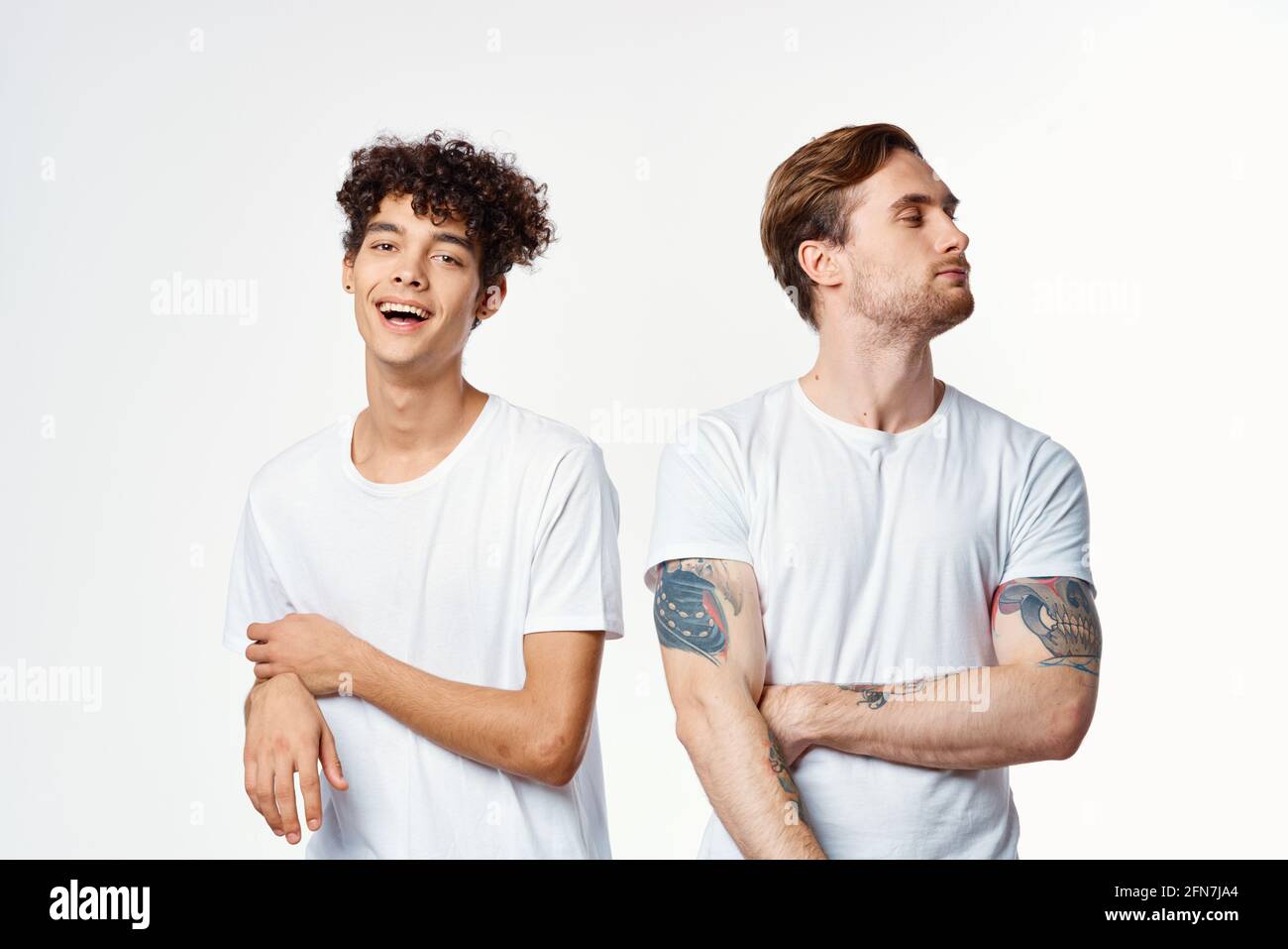 funny two men in white t-shirts are standing side by side isolated ...