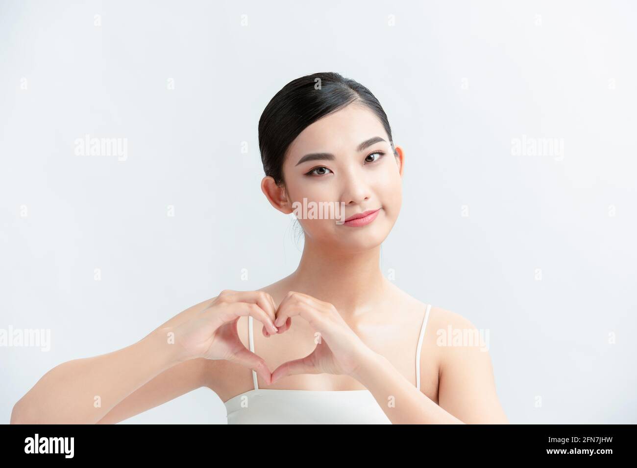 Woman holding hands to chest hi-res stock photography and images - Alamy