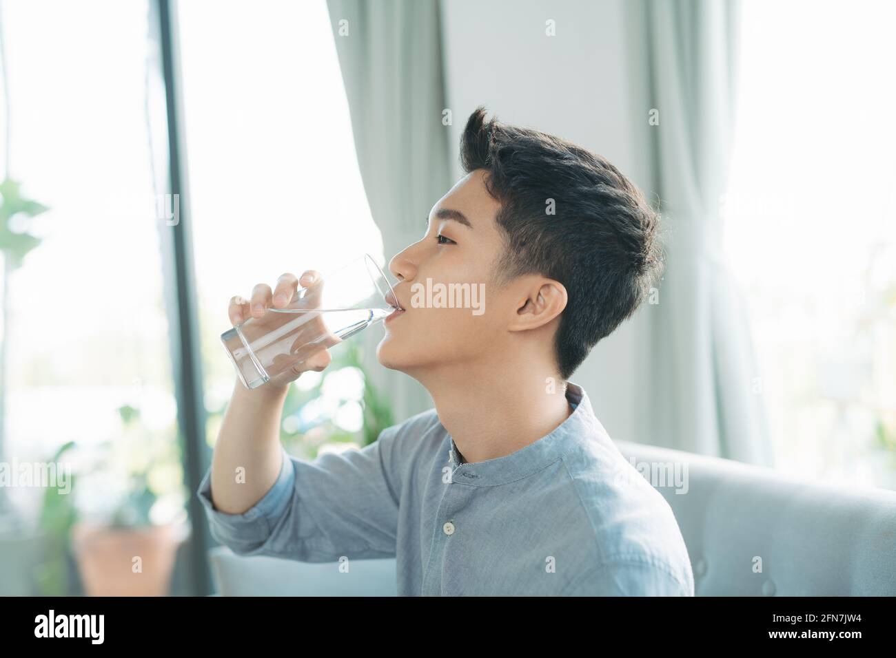 Asian man drinking from water hi-res stock photography and images - Alamy