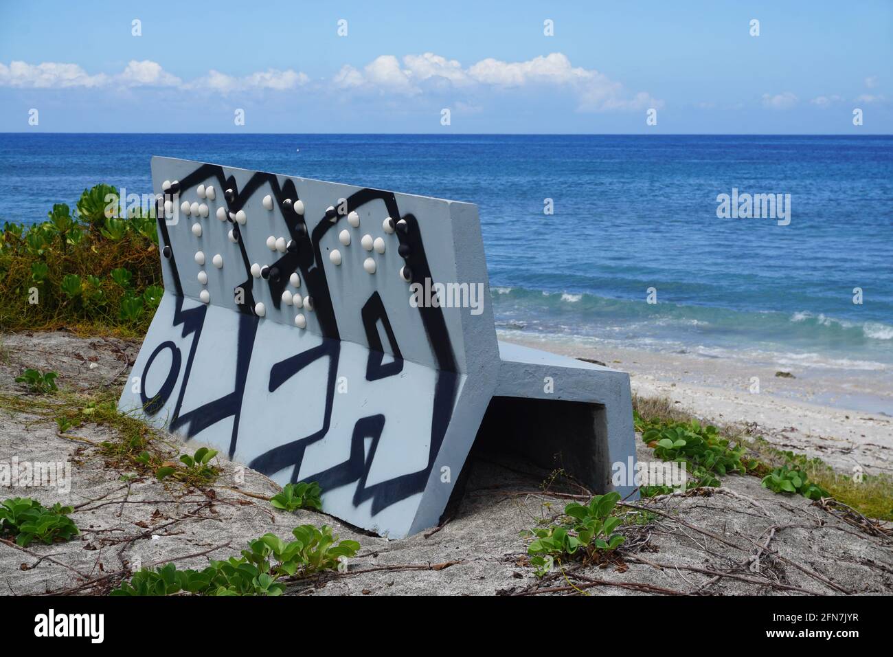 a stone bench with a view on the beach of the tropical island of La ...