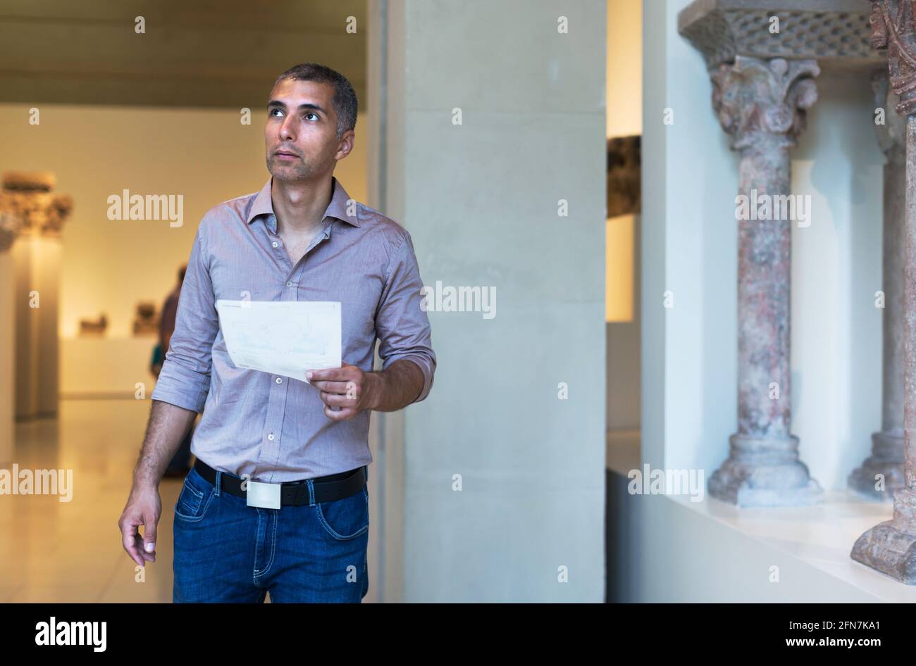 Adult man is visiting museum and looking at the exposition Stock Photo ...
