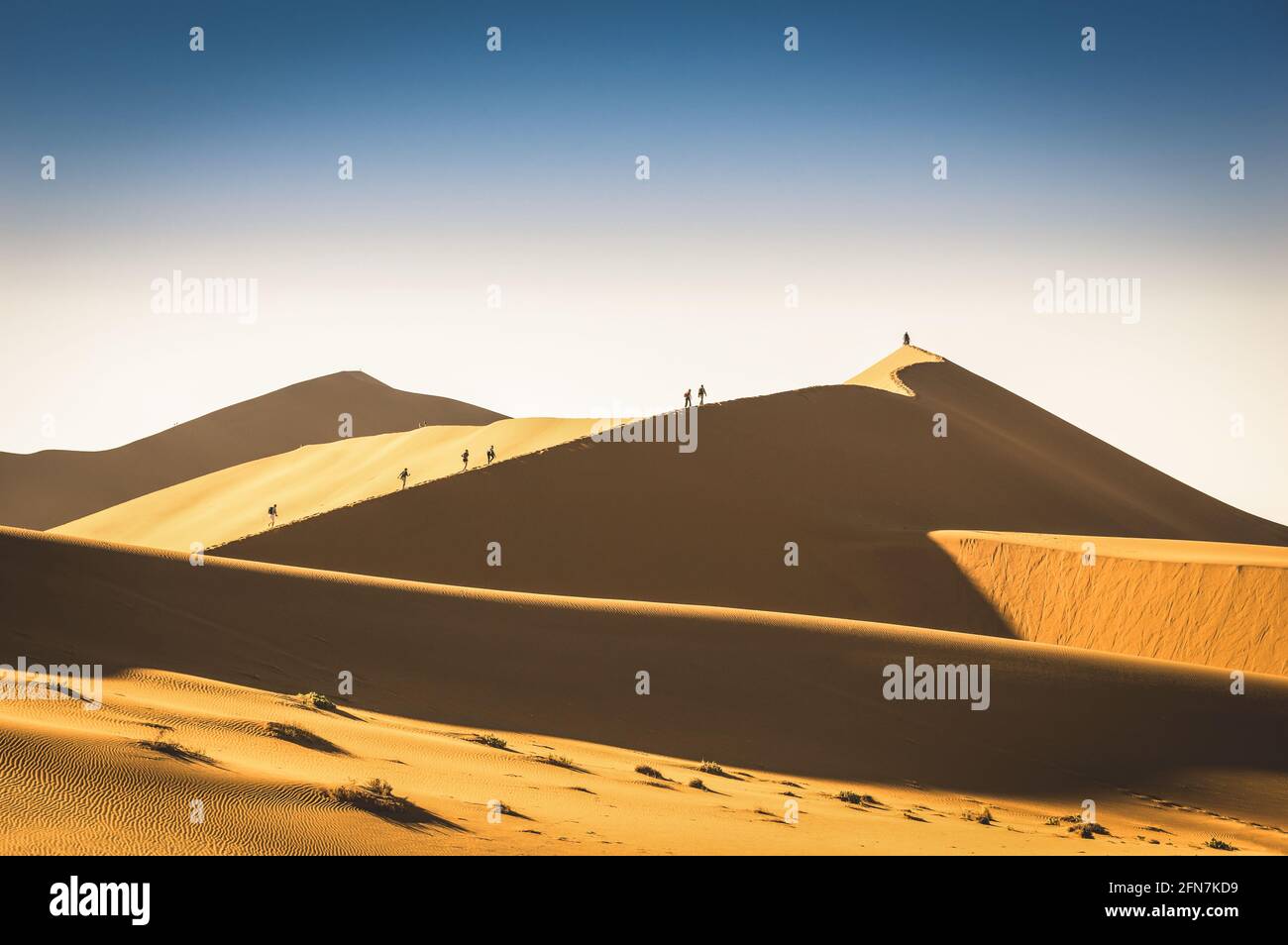 Tourist people travellers hiking on sand dune at Deadvlei near ...