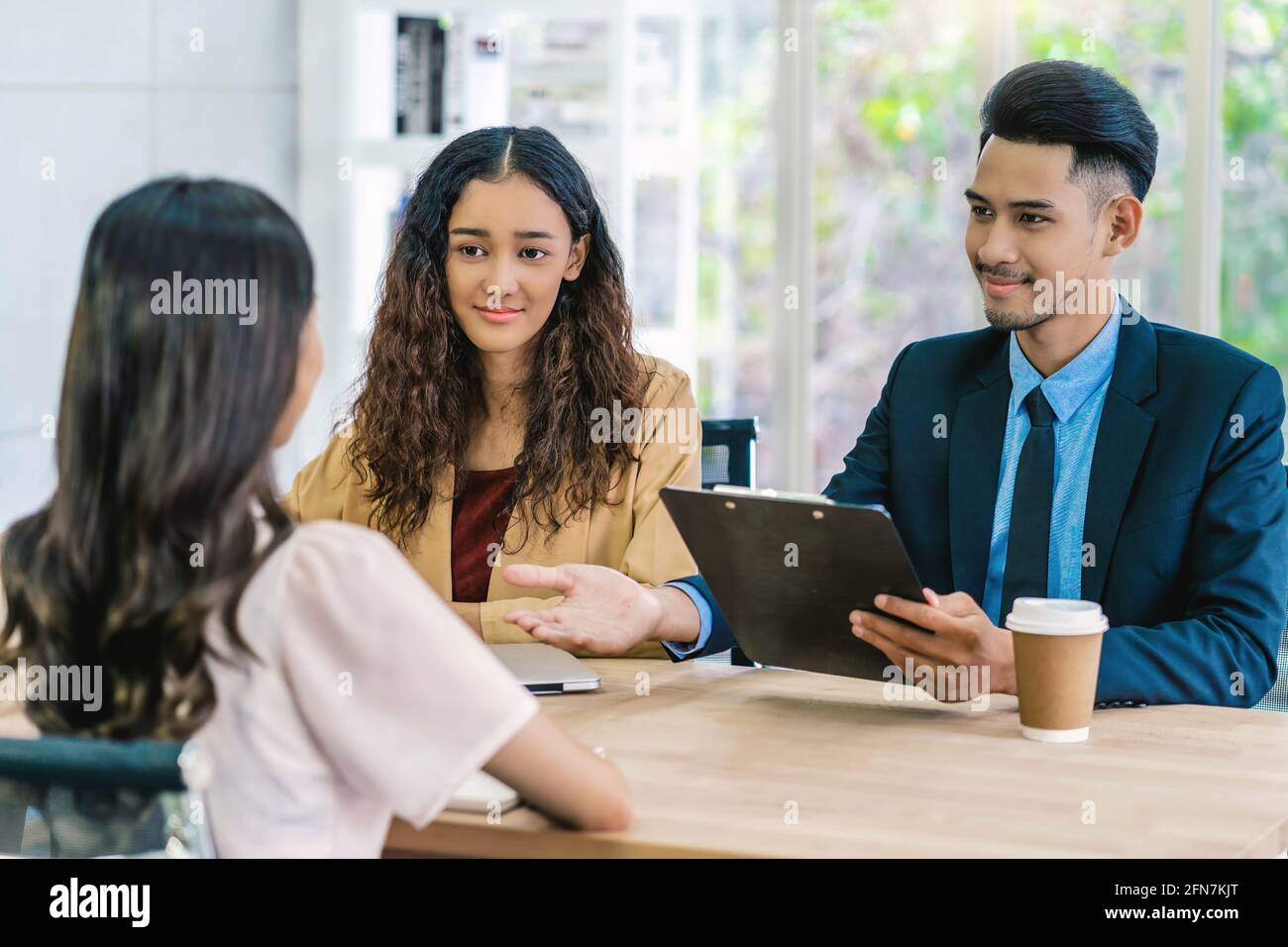 Senior Asian Manager explaining or answering about job description and ...