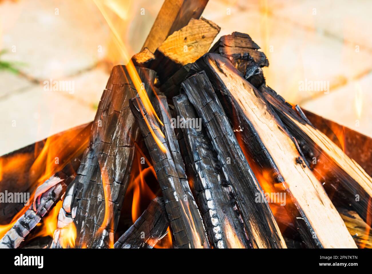 Closeup shot of fire with burning wood chips to form coal for barbecue ...
