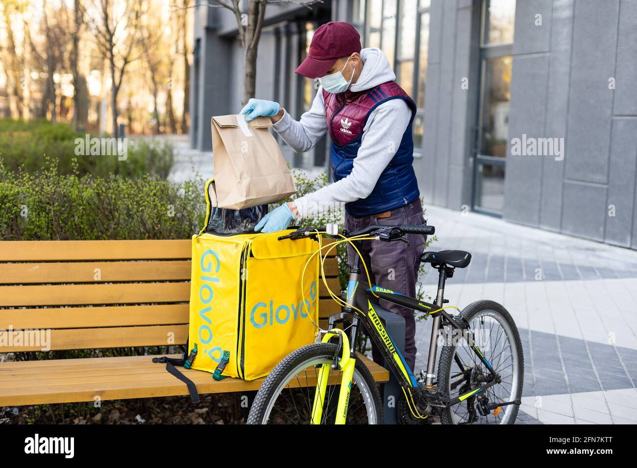 KIEV, UKRAINE - 28 April, 2021: Glovo delivery boy with famous yellow ...
