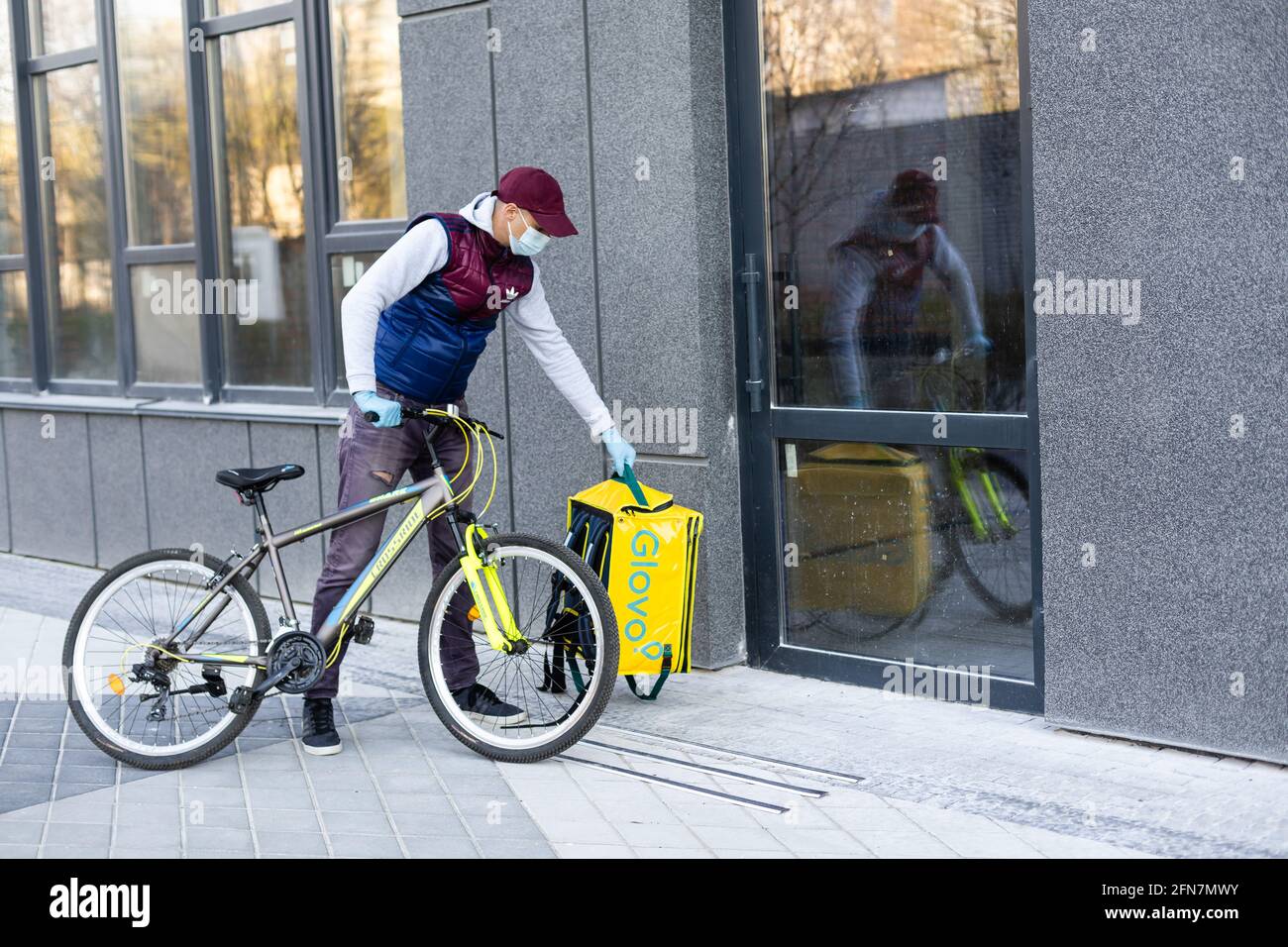 KIEV, UKRAINE - April 28, 2021: Glovo bike courier on the street ...