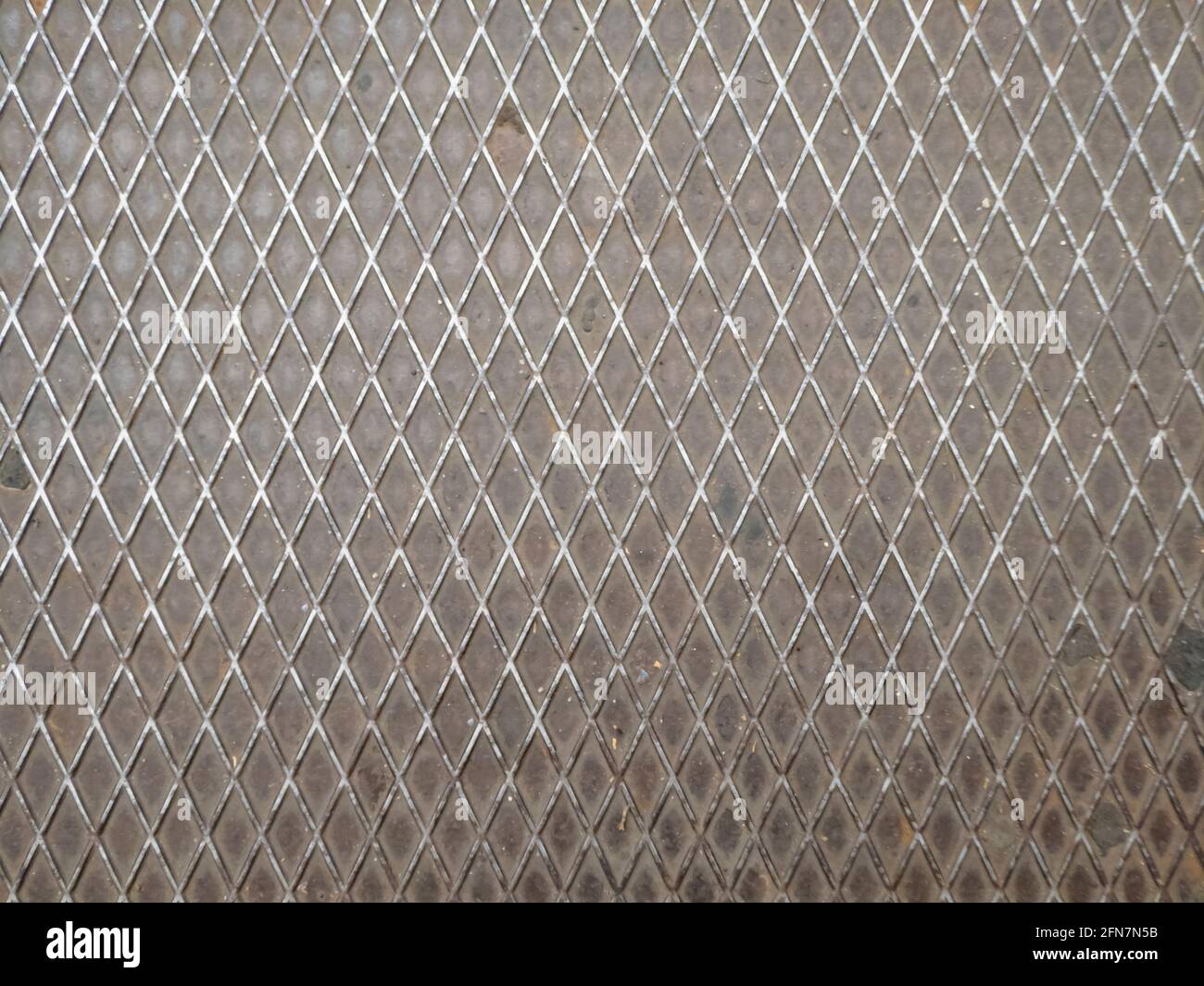 Metal plate with triangular texture on the city floor Stock Photo - Alamy