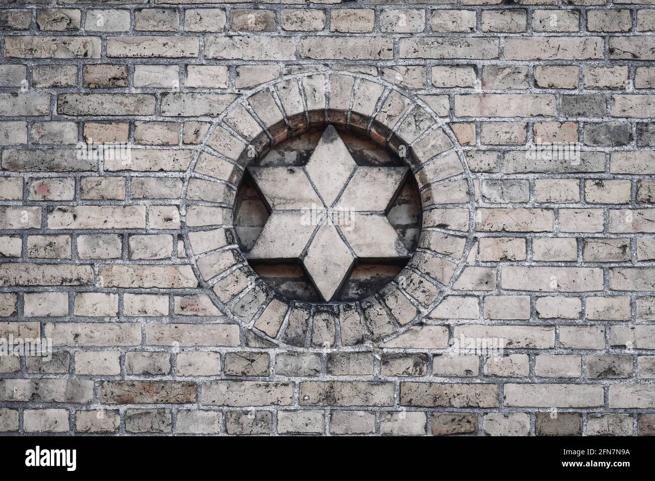 Photo of a brick exterior wall with a star Stock Photo - Alamy