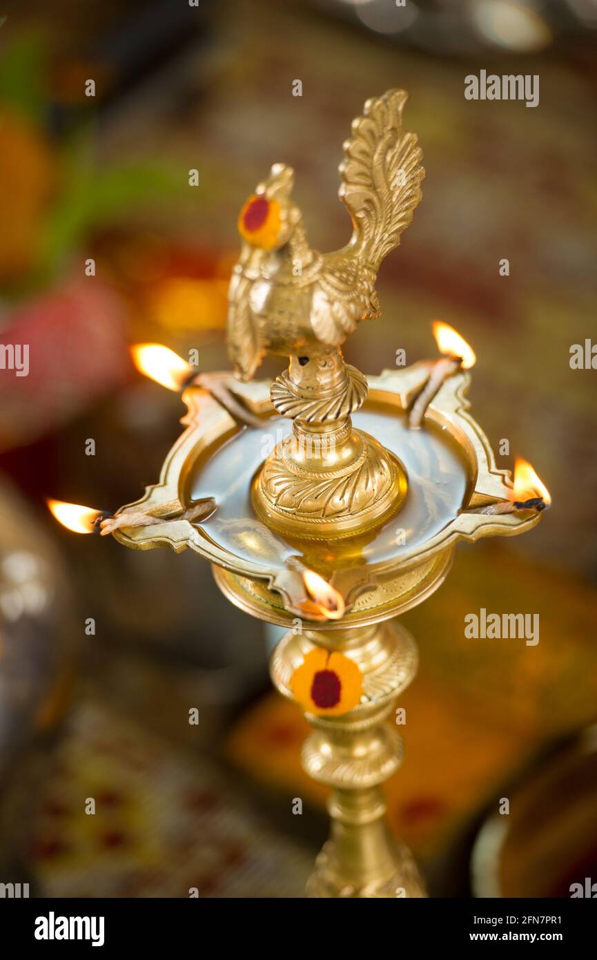 Golden samai oil lamp with bird Stock Photo - Alamy