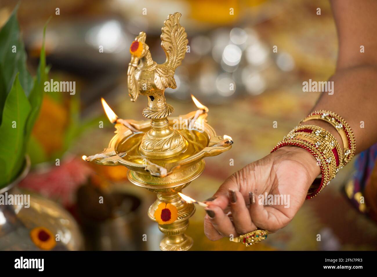 Female hand lighting the Samai oil lamp Stock Photo - Alamy