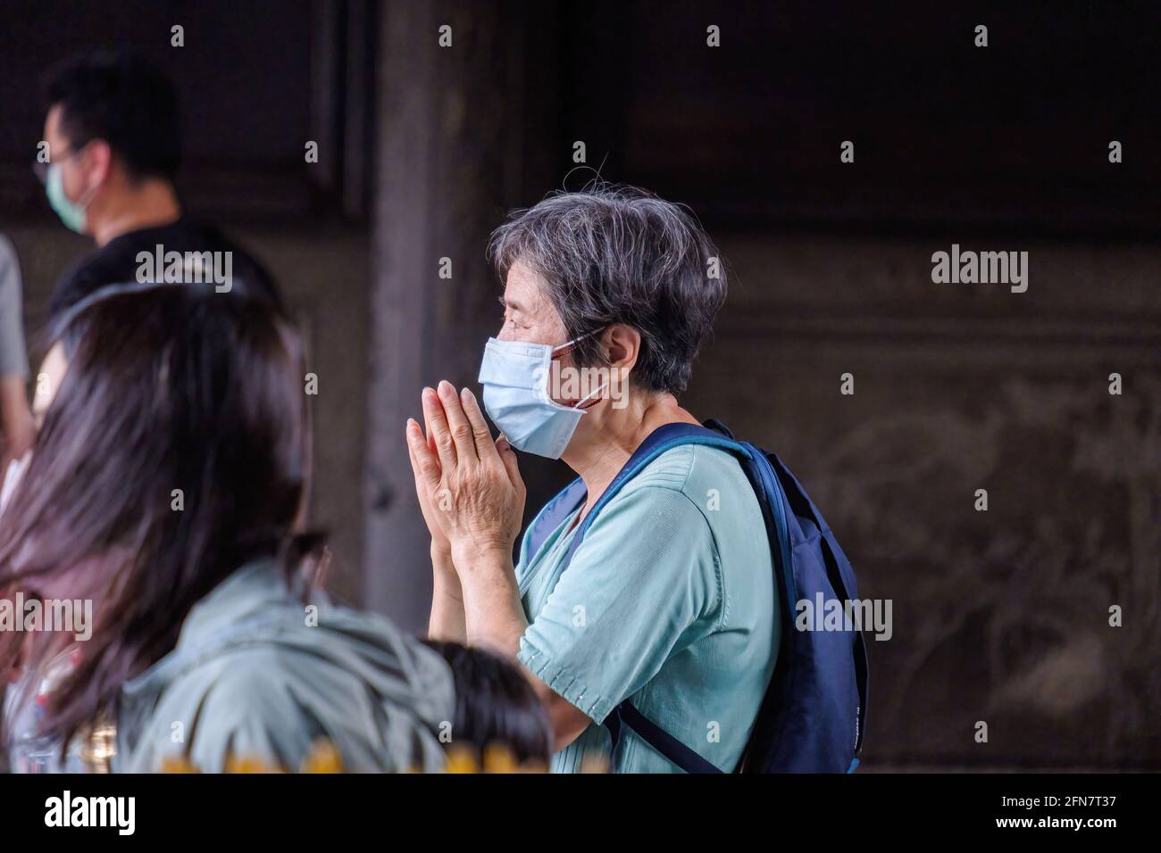 Taipei, Taiwan. 13th May, 2021. A man wearing a face mask prays inside ...