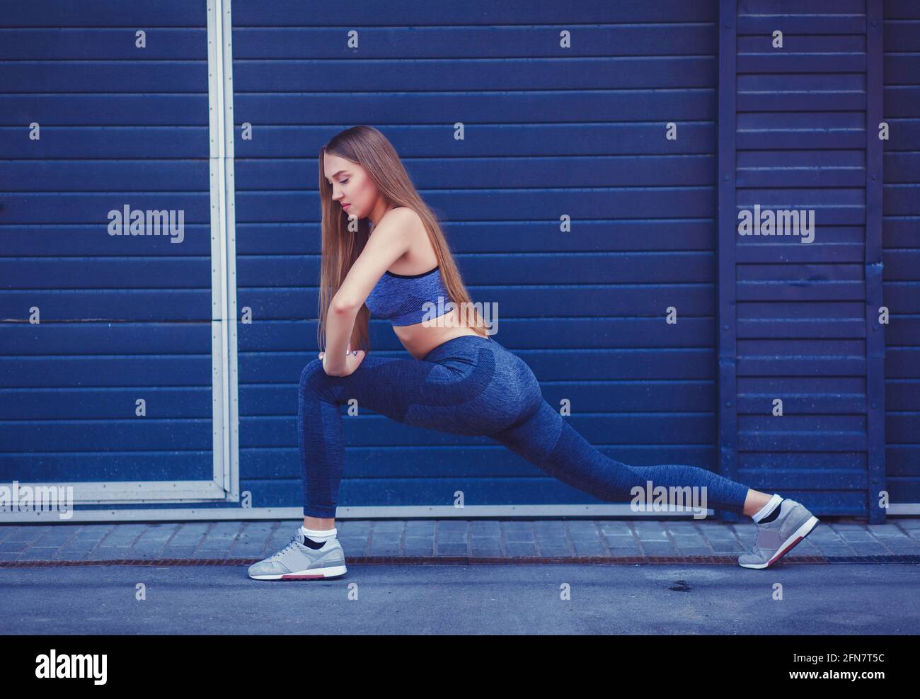 Happy slim woman stretching before running outdoors Stock Photo - Alamy