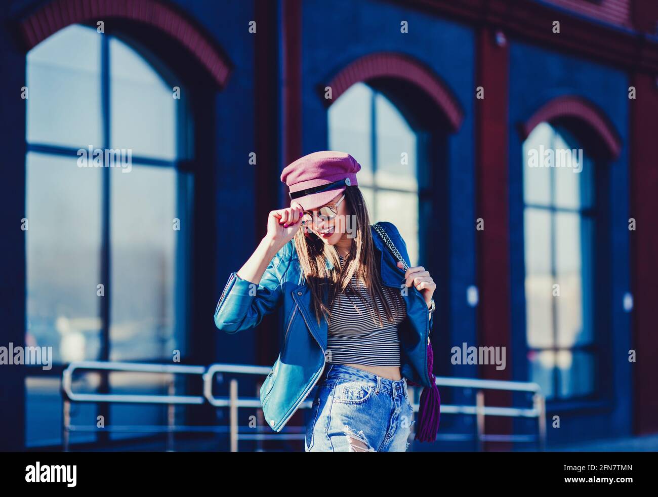 fashion smiling model in hat wearing sunglasses and posing outdoor ...