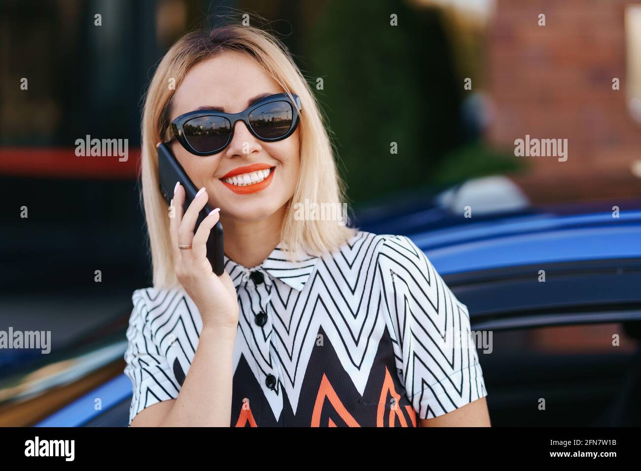 Woman using mobile phone, communication or online application, standing ...