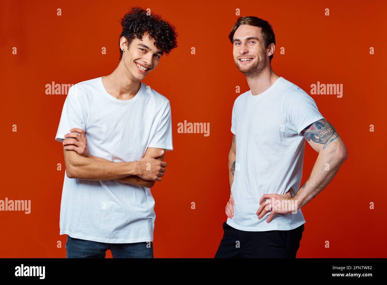 funny two men in white t-shirts on a red background friendship Stock ...