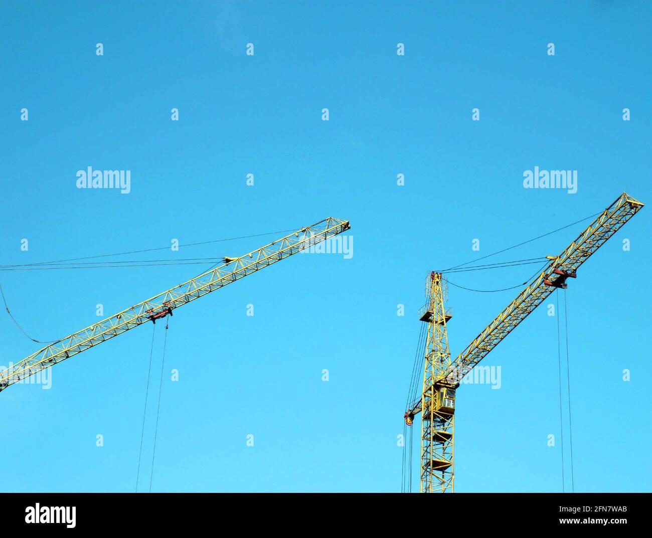 two crane towers on sky background at day Stock Photo - Alamy