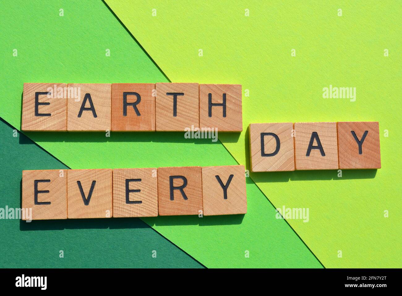 Earth Day, Every Day, words in wood alphabet letters isolated on green ...