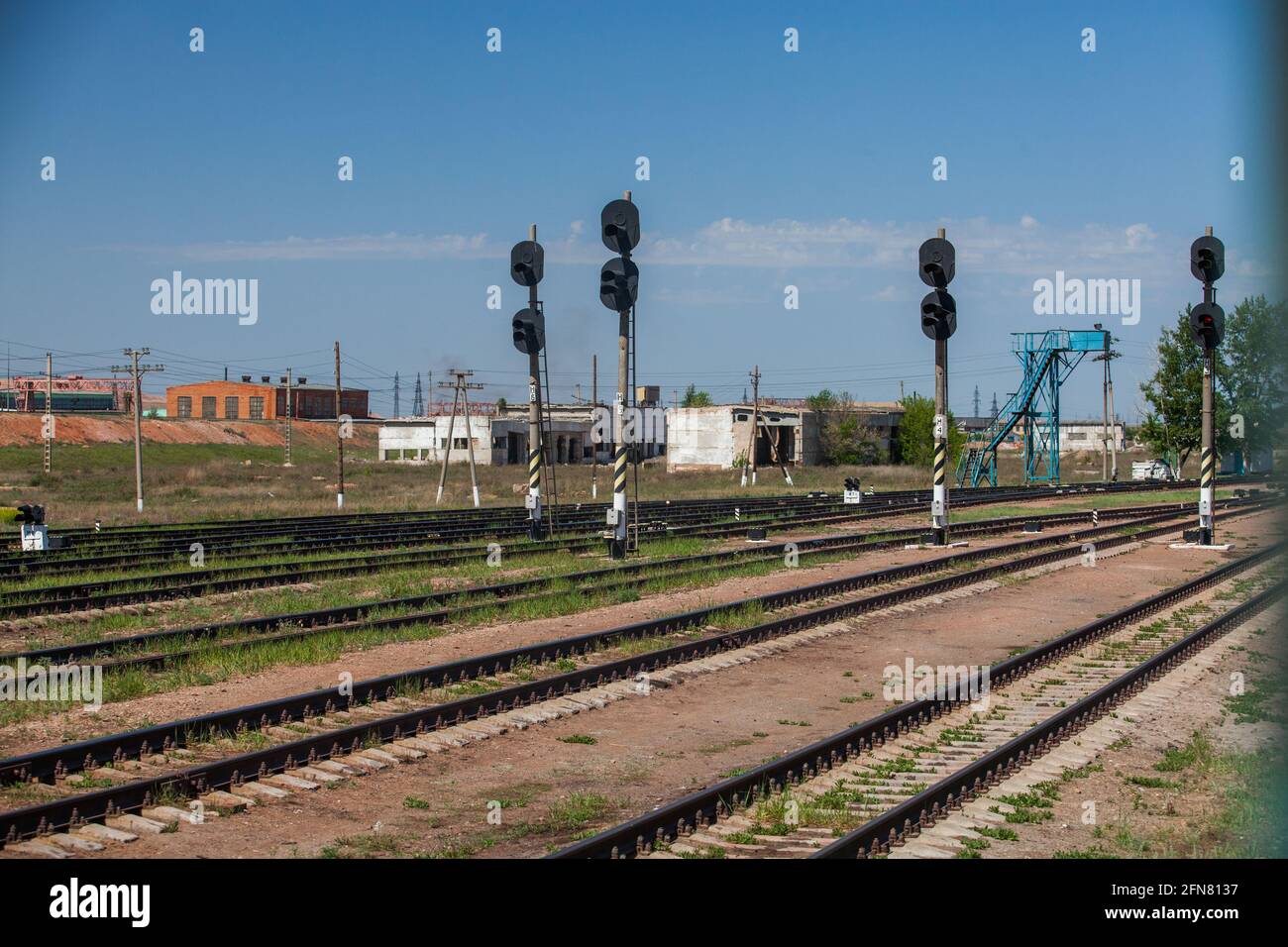 Old Soviet railway station in industrial zone. Rail with concrete ...