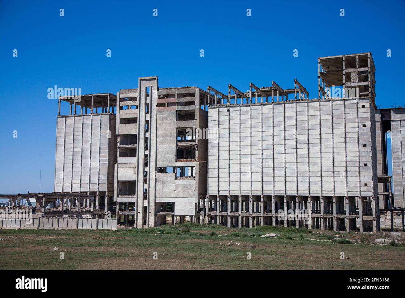 Outdated Soviet concrete grain elevator. Partially destroyed building ...