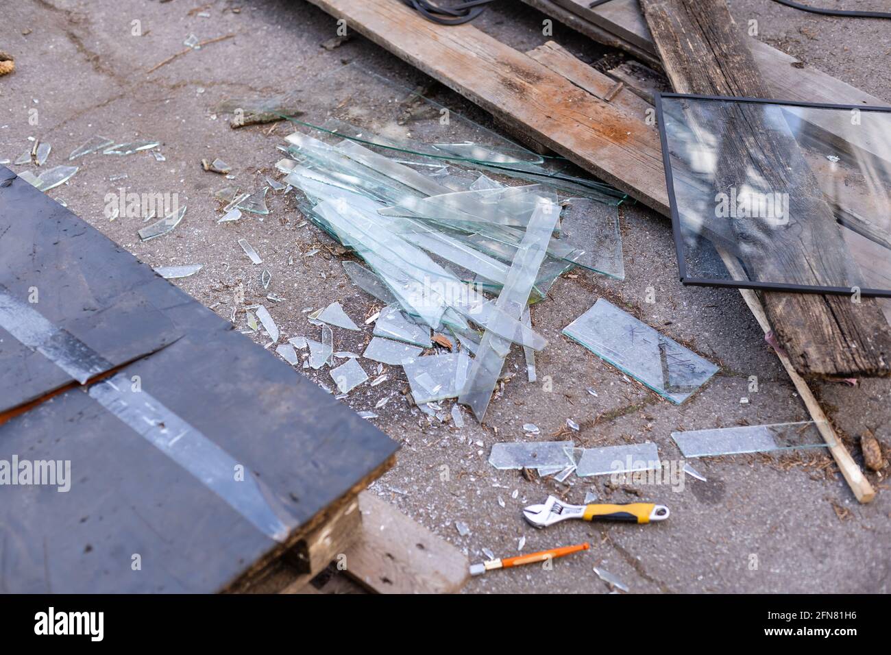 Stained glass shards and waste in a glass studio container. The hot ...