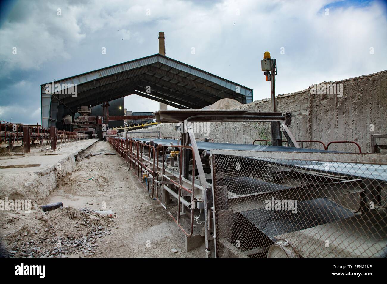 Temirtau, Kazakhstan: Old Soviet cement plant. Rubber conveyor belt on ...