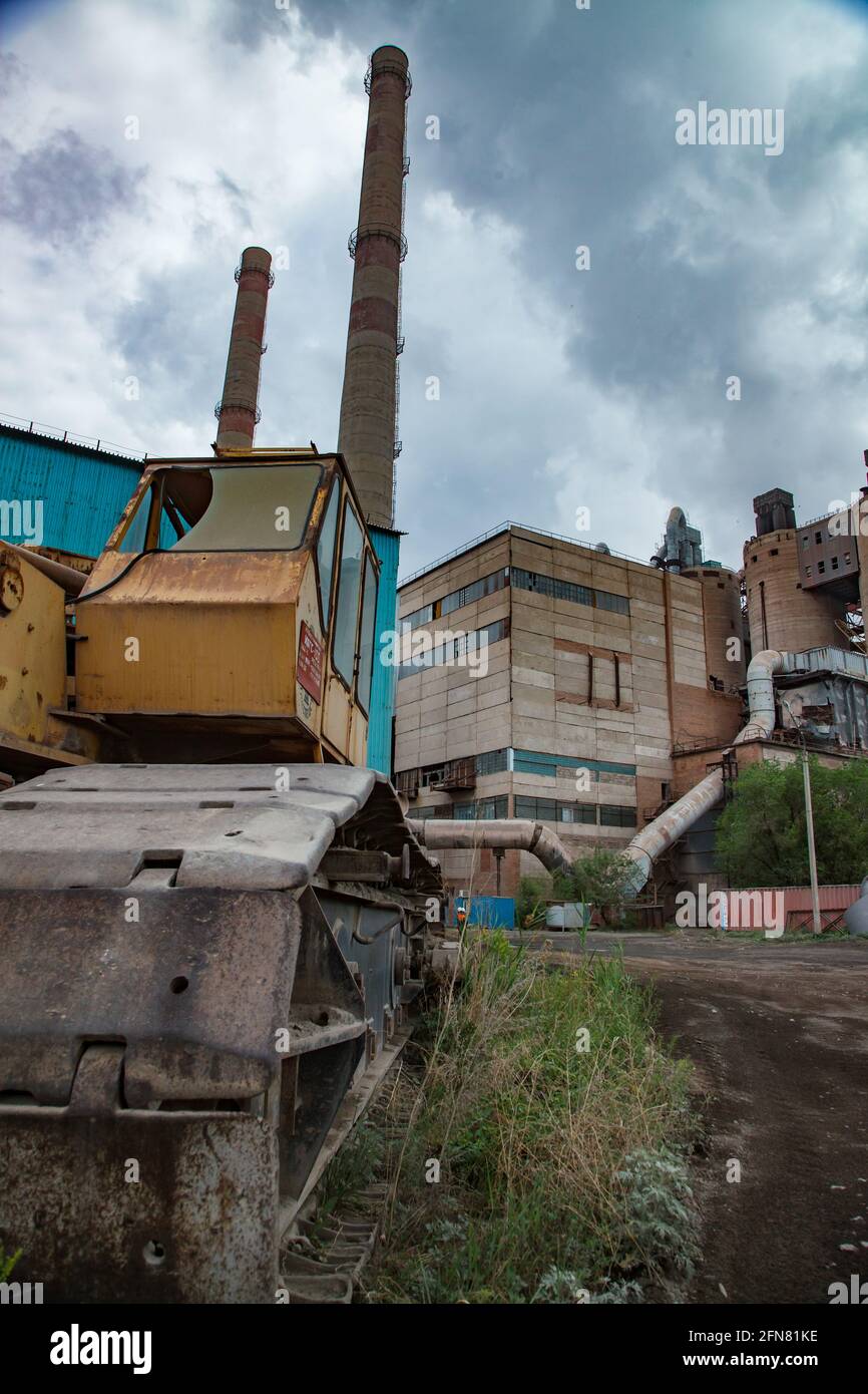 Temirtau, Kazakhstan: Outdated Soviet cement plant. Old bulldozer left ...