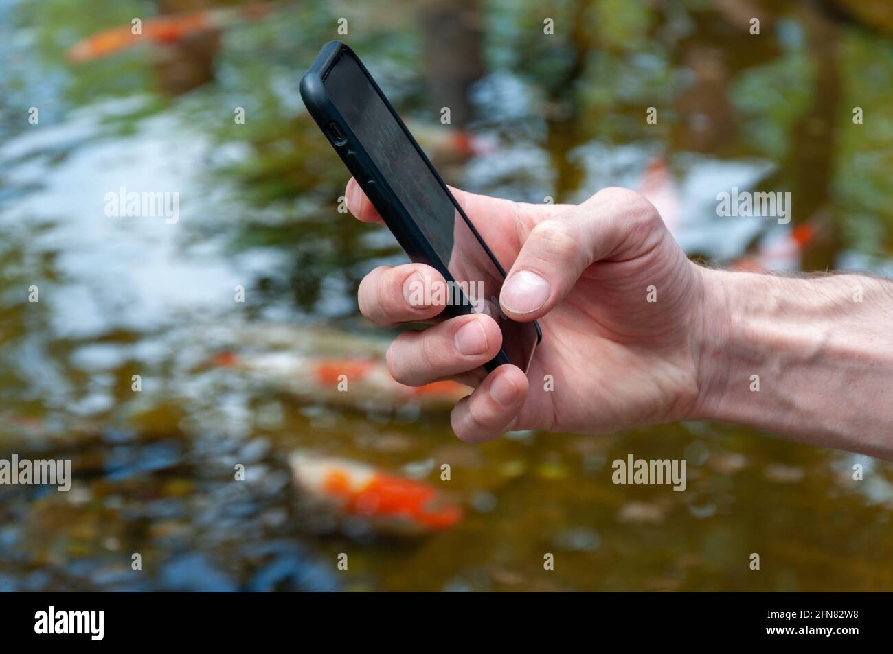 Man holding smartphone, closeup of hand. Process of taking a photo ...