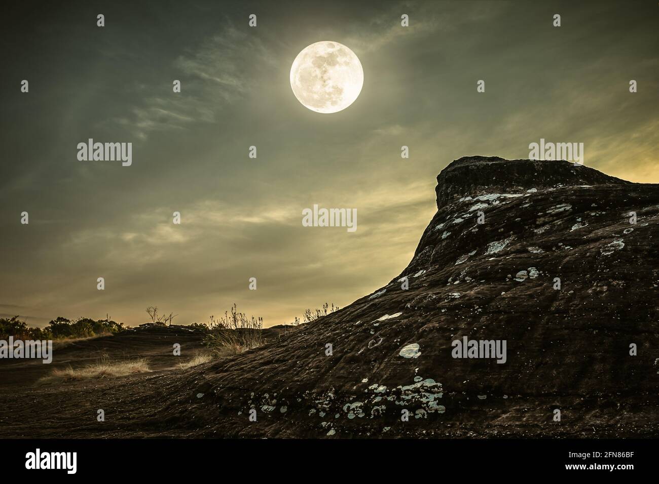 Landscape of the rock against night sky and bright full moon above ...