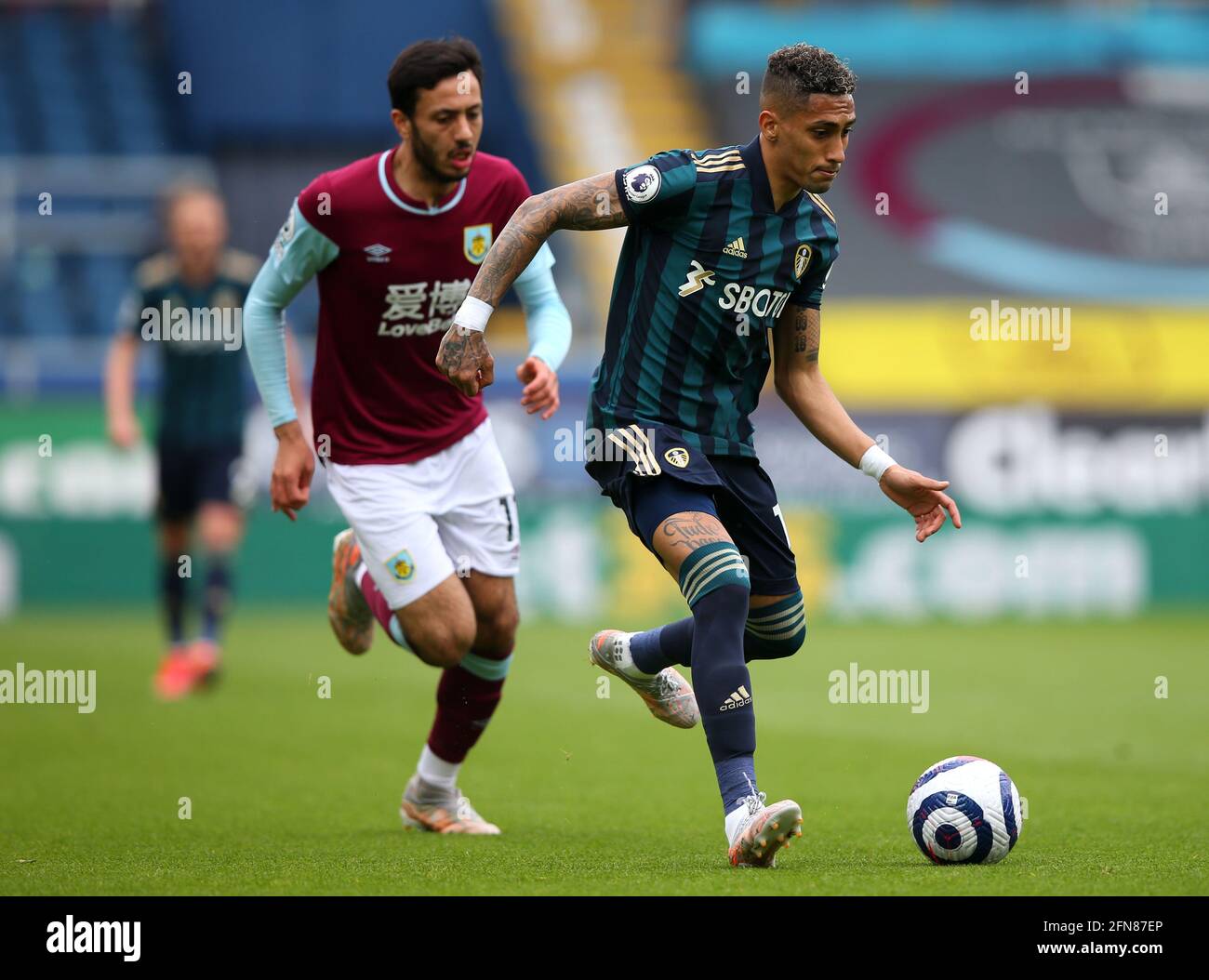 Burnley's Dwight McNeil (left) and Leeds United's Raphinha (right ...