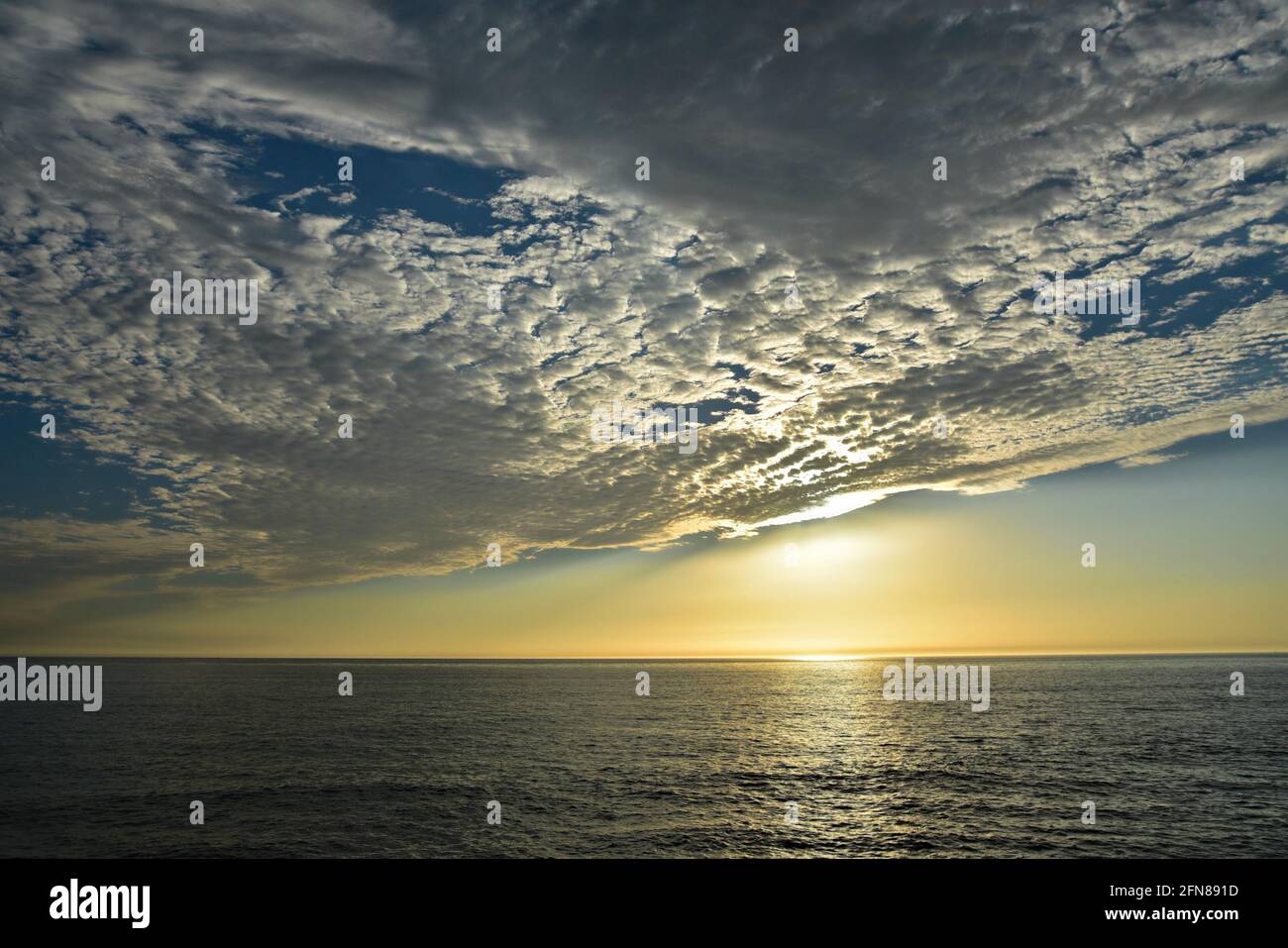 Scenic sunset seascape with spectacular cloud formations at Sunset ...
