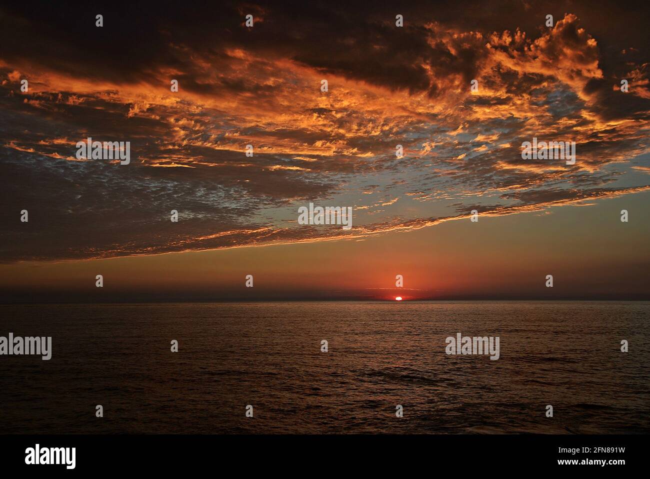 Scenic sunset seascape with spectacular cloud formations at Sunset ...