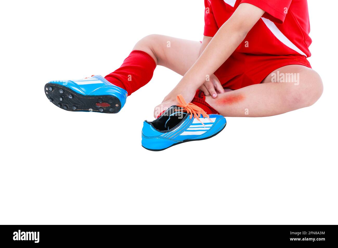 Sports injure. Youth asian soccer player in red uniform injured at leg ...