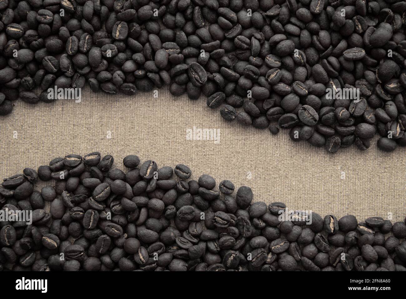 Roasted black coffee beans background Stock Photo - Alamy