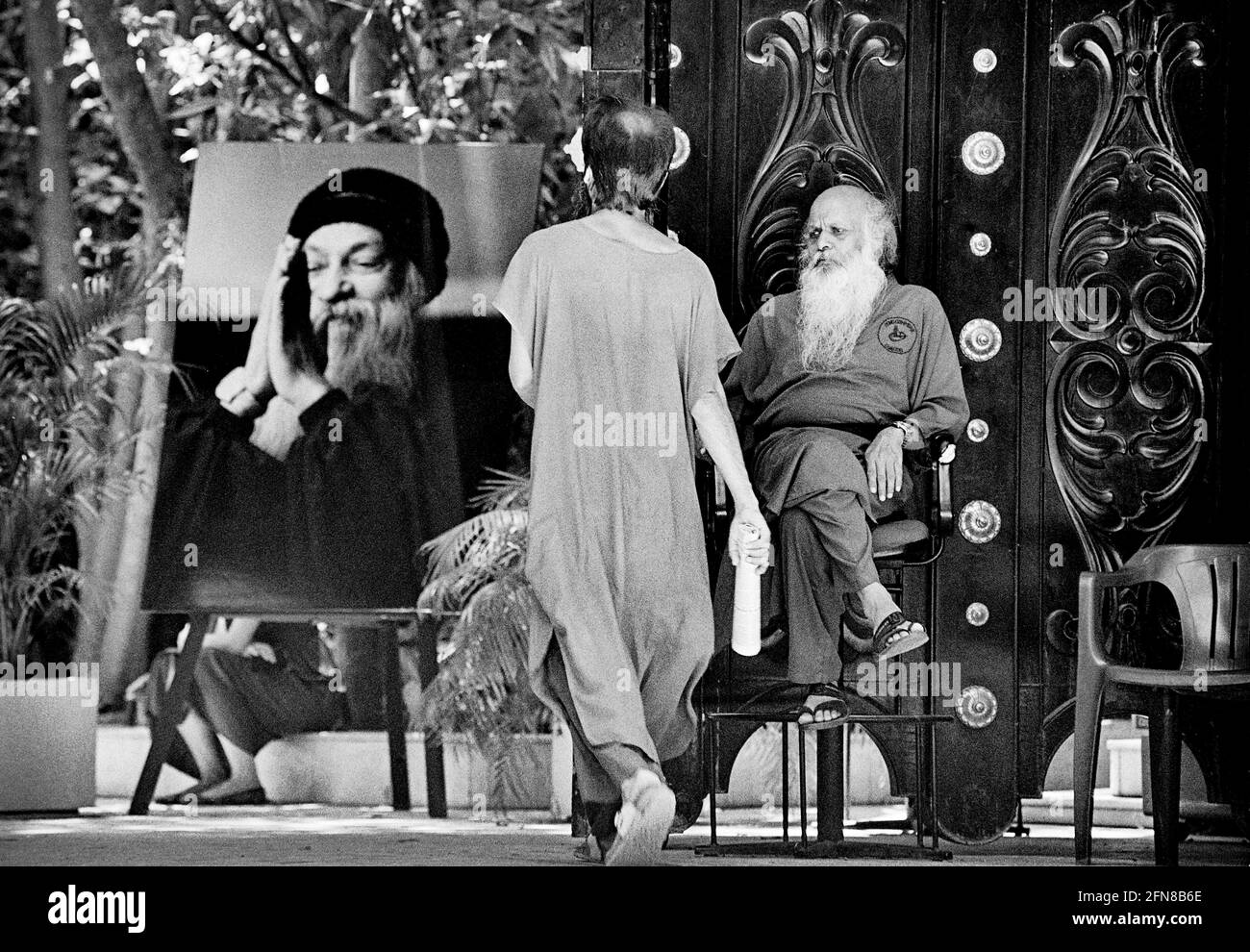 The entrance to the ashram is controlled by a bearded sannyasin. On a ...