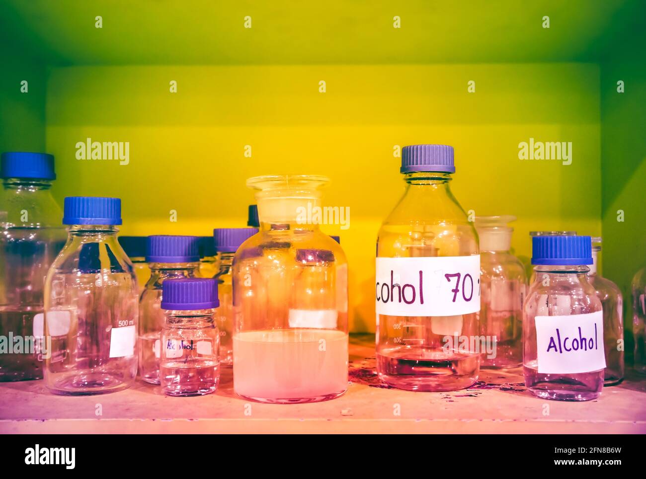 Group of chemical laboratory glassware equipment. Alcohol bottles on ...