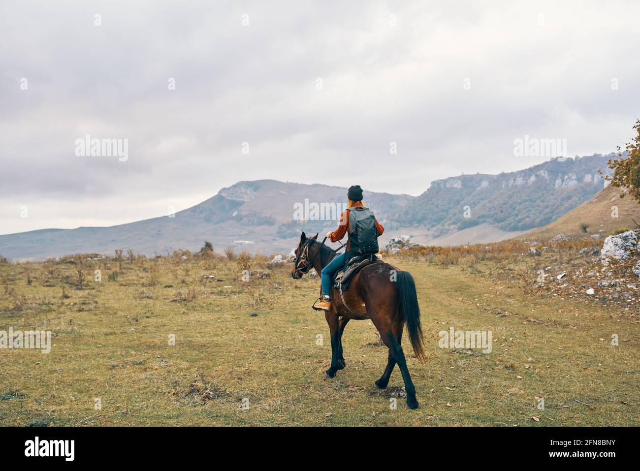 woman hiker with backpack riding horse landscape mountains fresh air ...