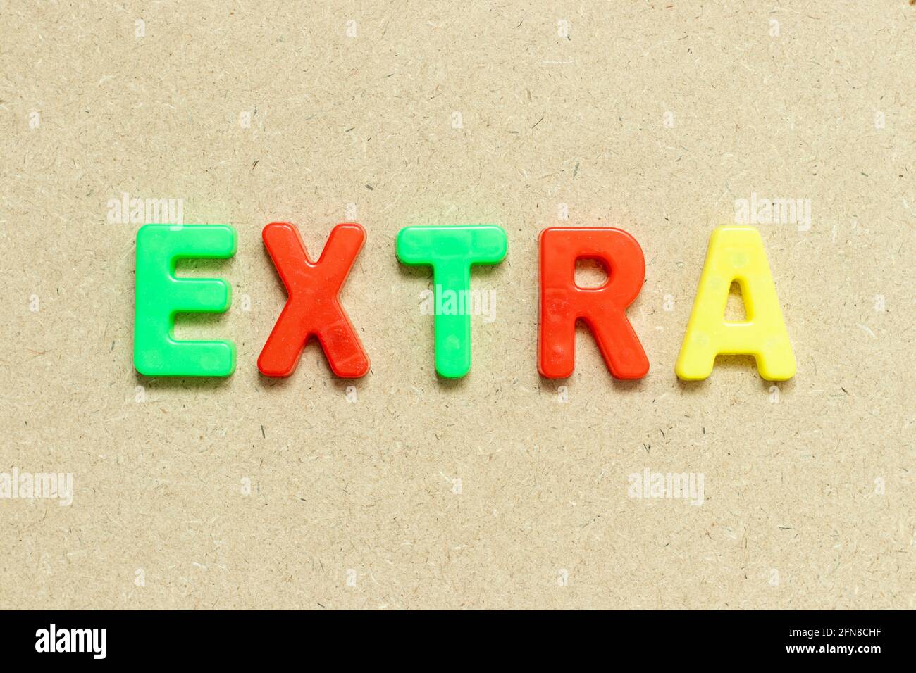 Color alphabet letter with word extra on wood background Stock Photo ...