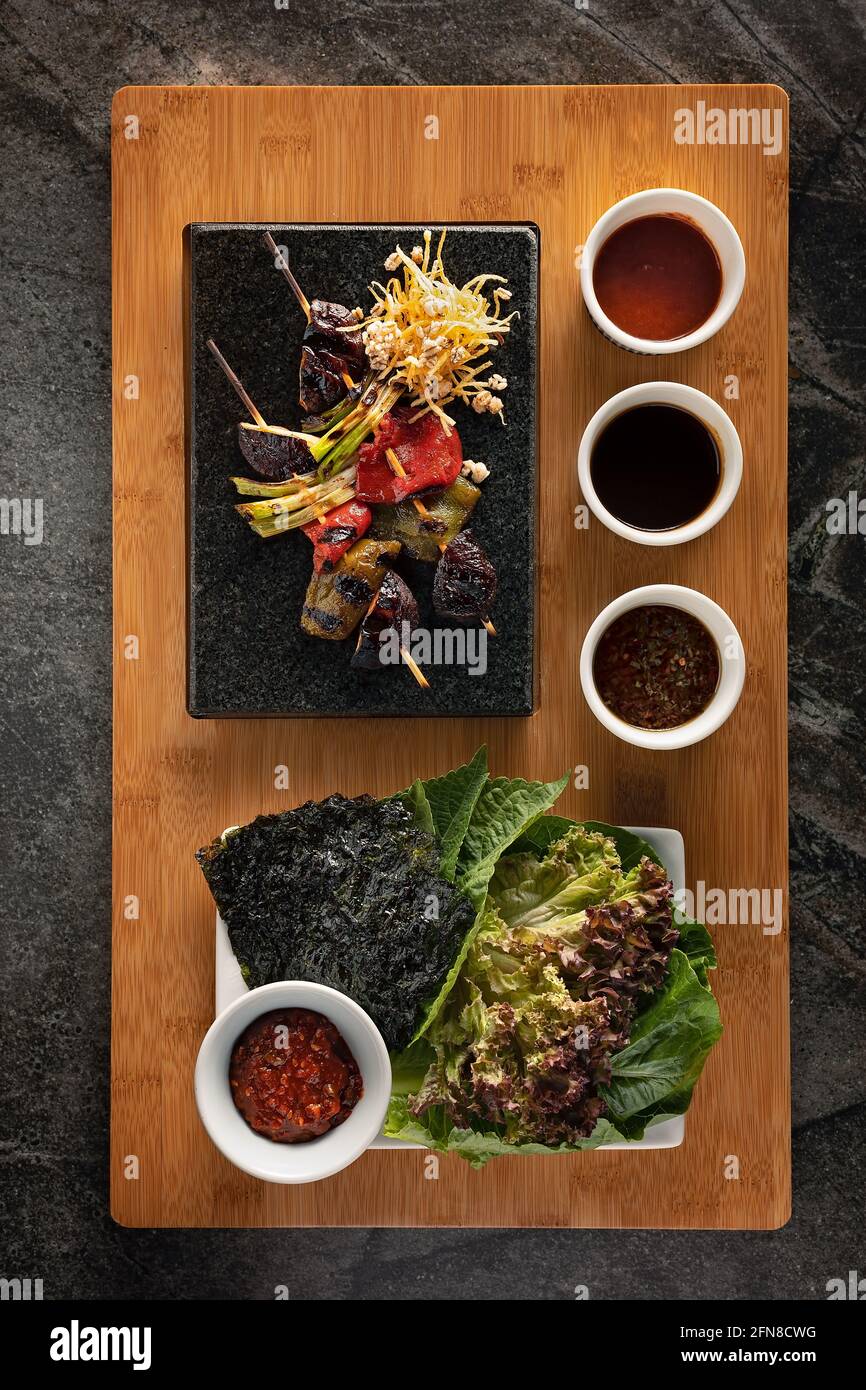 Flat lay of a Korean food board with vegetables skewers, salads ...