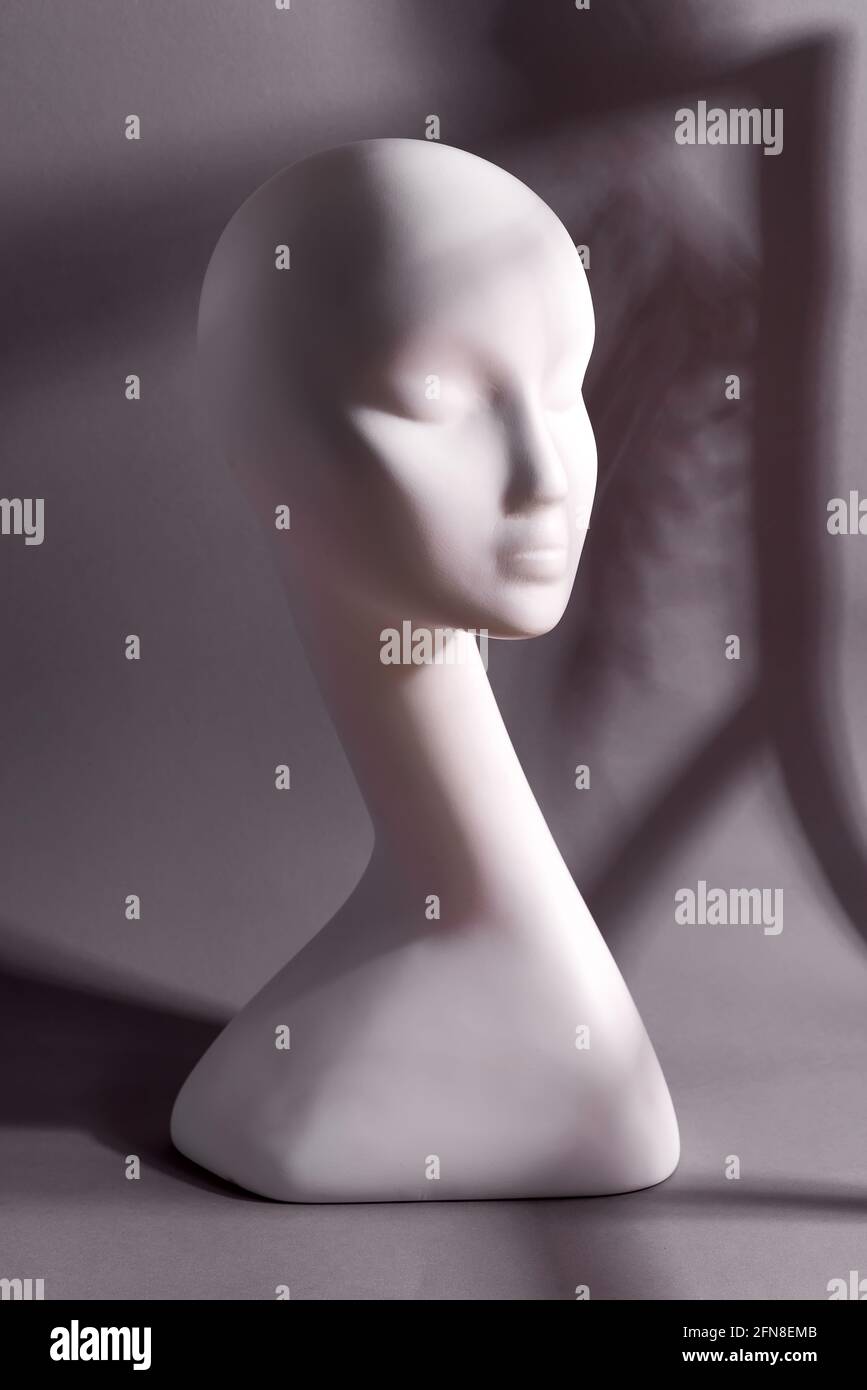Head of a white mannequin on a grey background. Faceless girl Stock ...