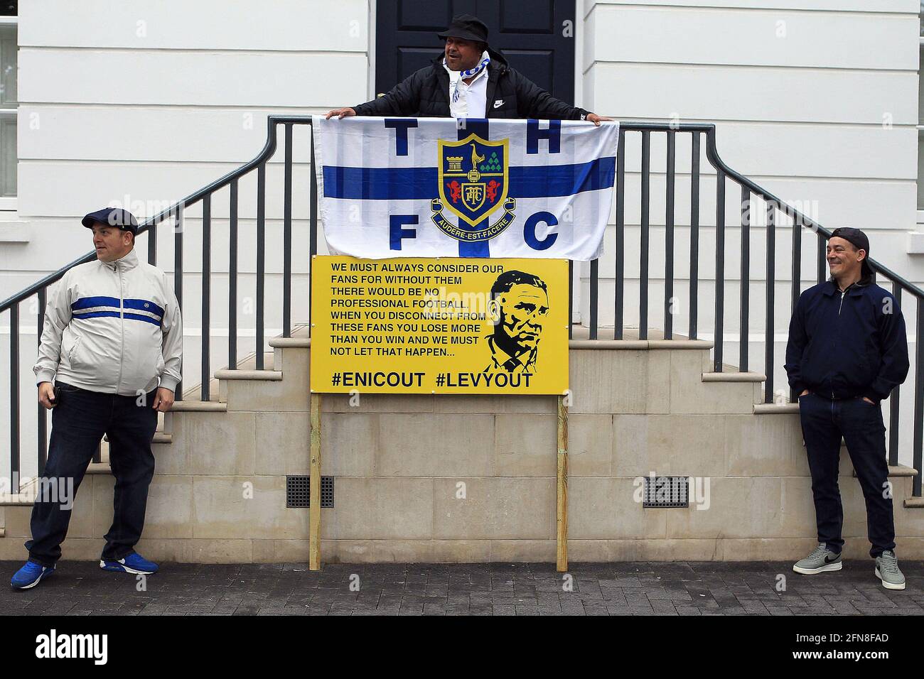 Tottenham supporters hold up a flag along with a banner outside the ...