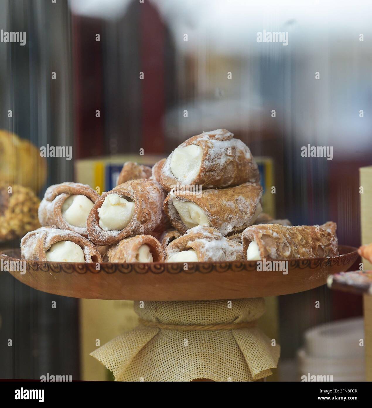 Freshly made Italian cannoli on display in a Brighton cafe window ...