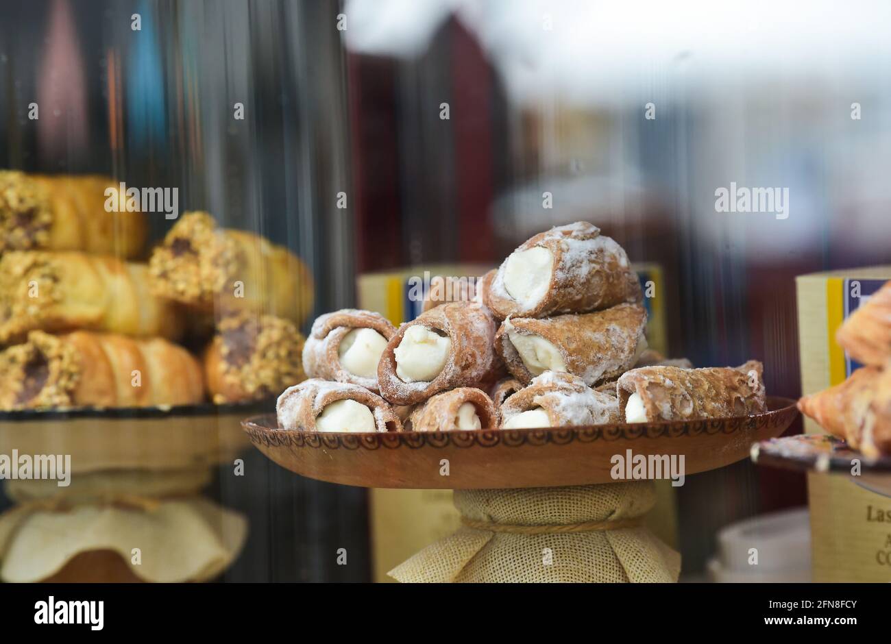 Freshly made Italian cannoli on display in a Brighton cafe window ...