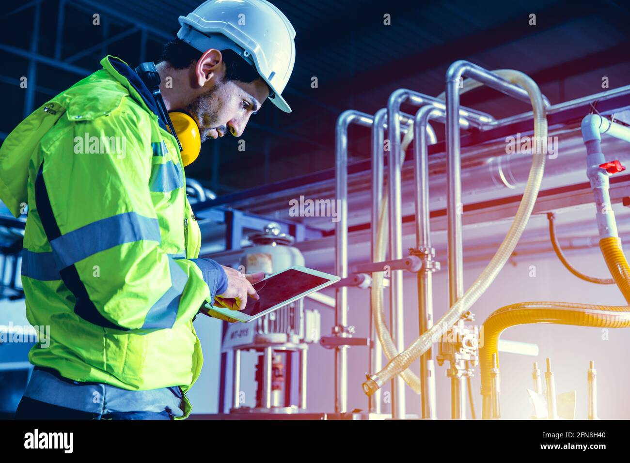 Factory worker engineer working in factory using tablet computer to ...