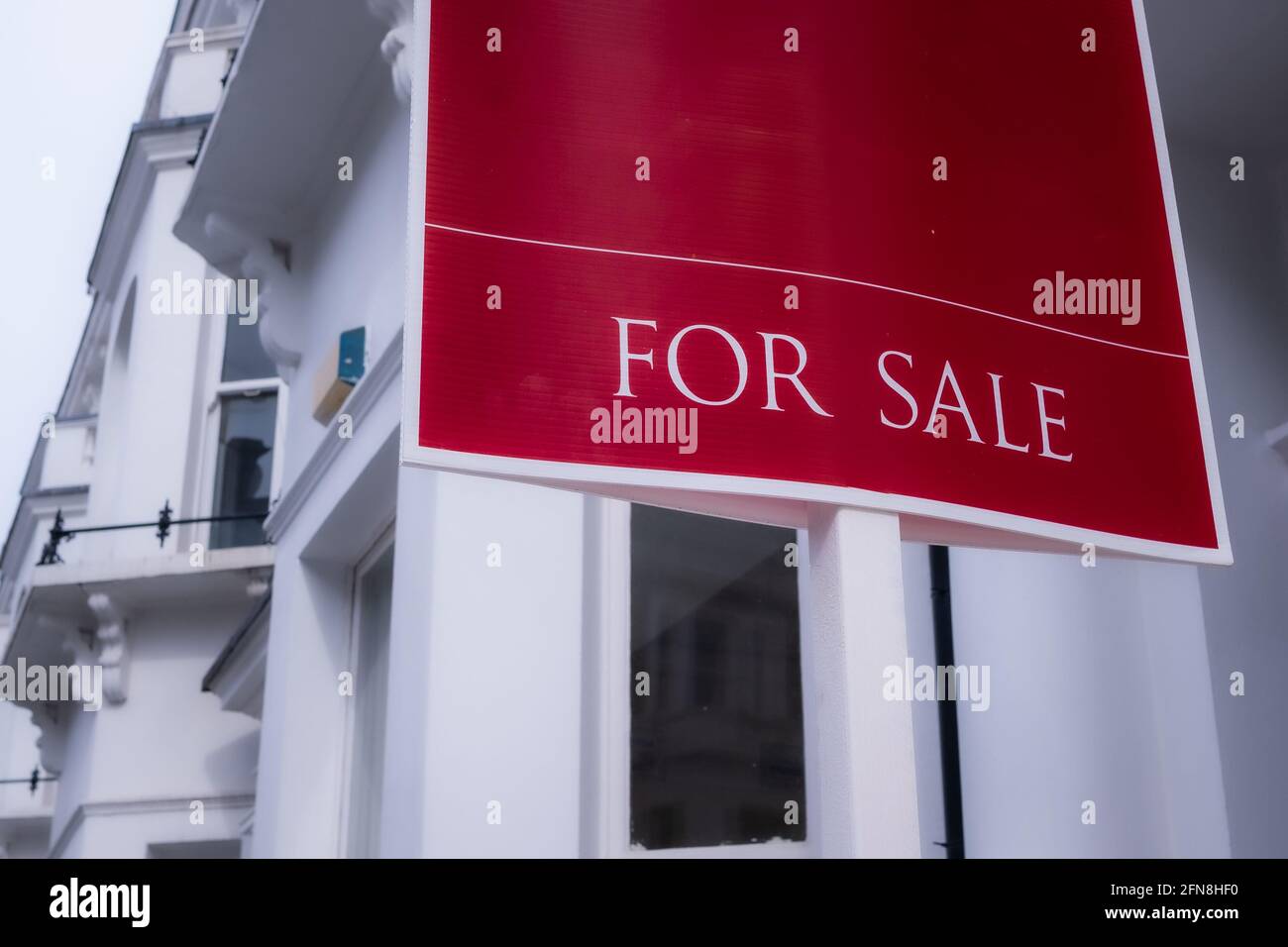Estate agent For Sale sign on street of houses Stock Photo - Alamy