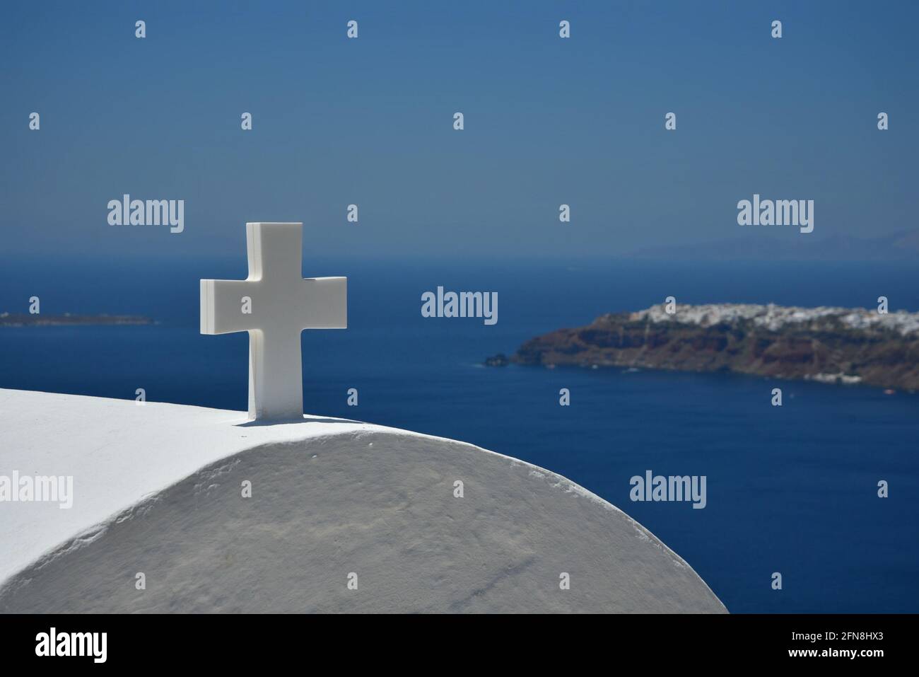 Traditional whitewashed Greek Orthodox chapel marble cross overlooking ...