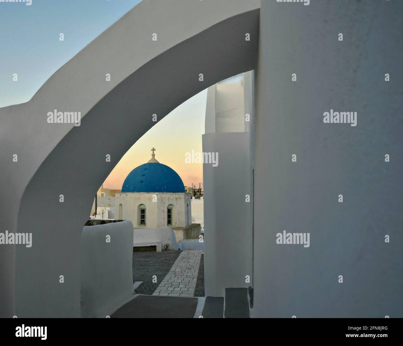 Sunset landscape with a traditional whitewashed Greek Orthodox church ...