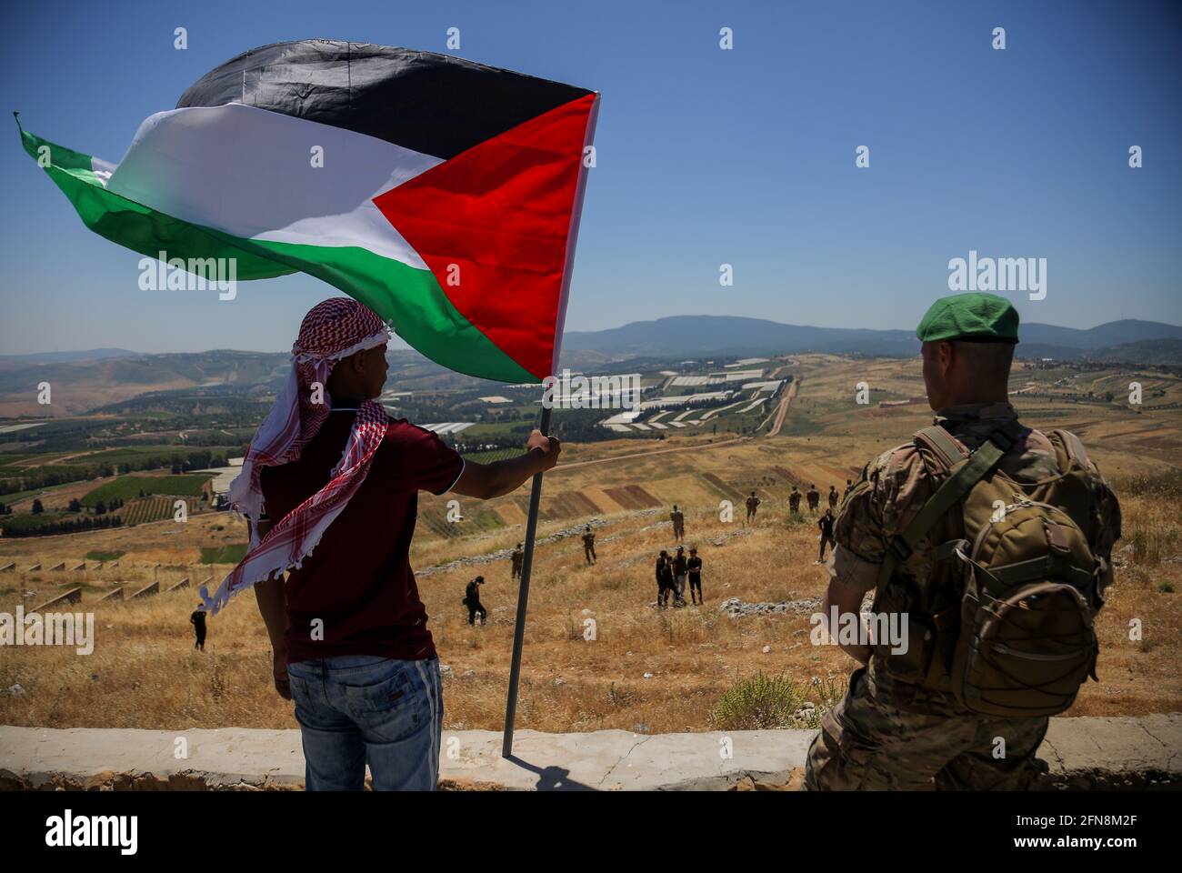 Maroun Al Ras, Lebanon. 15th May, 2021. A Palestinian flying the ...